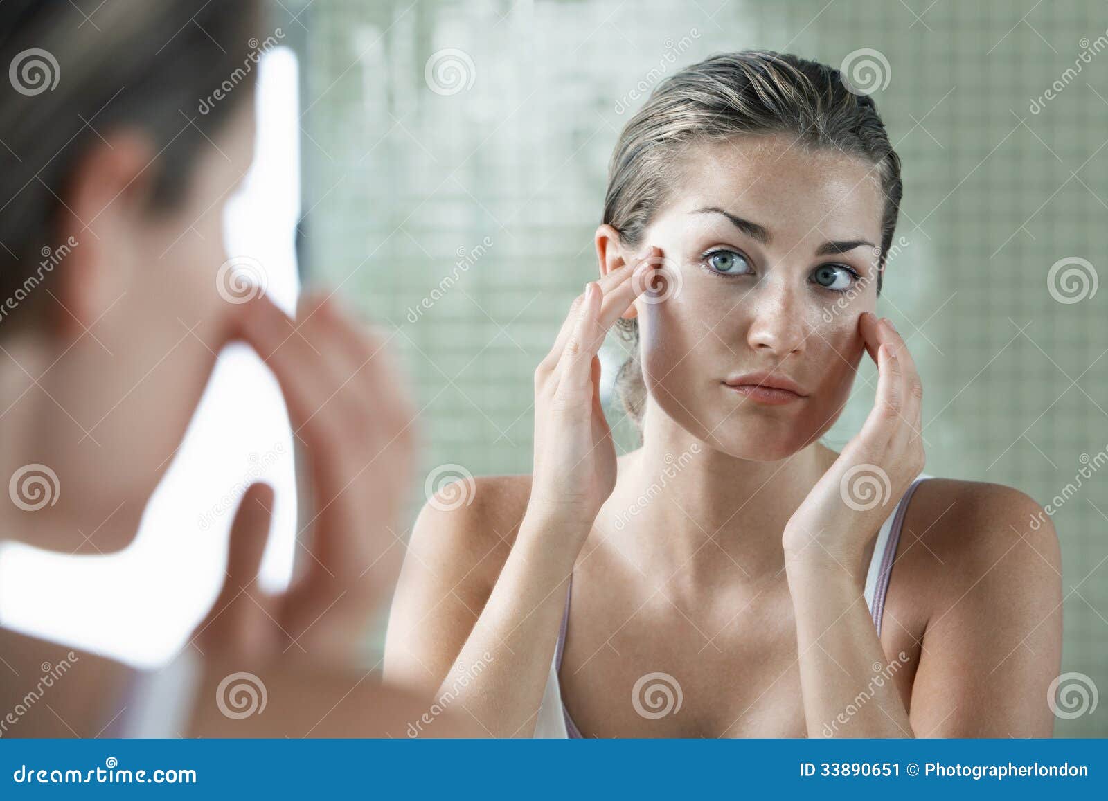 Woman Examining Herself in Front of Mirror Stock Image - Image of ...