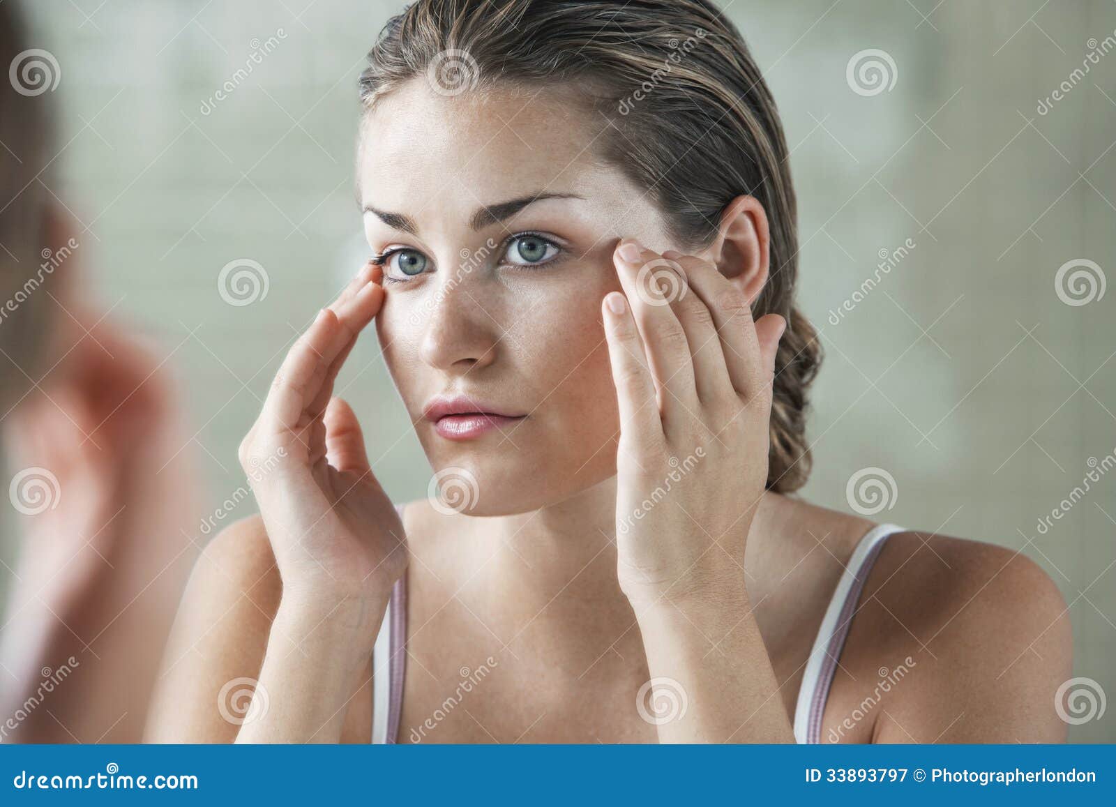 Woman Examining Herself in Front of Mirror Stock Image - Image of ...