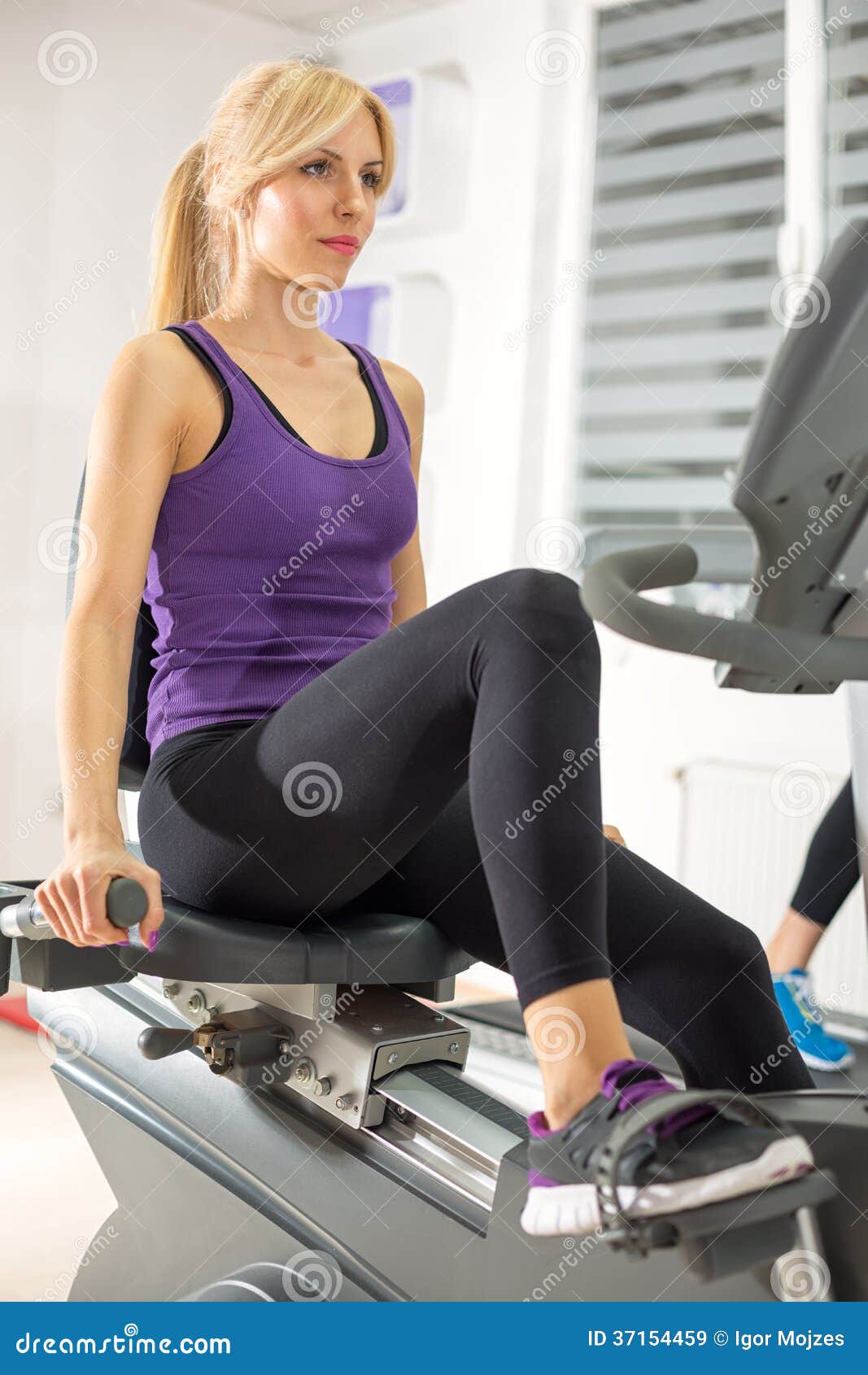 Woman Exercising at the Gym on a Machine Stock Image - Image of ...