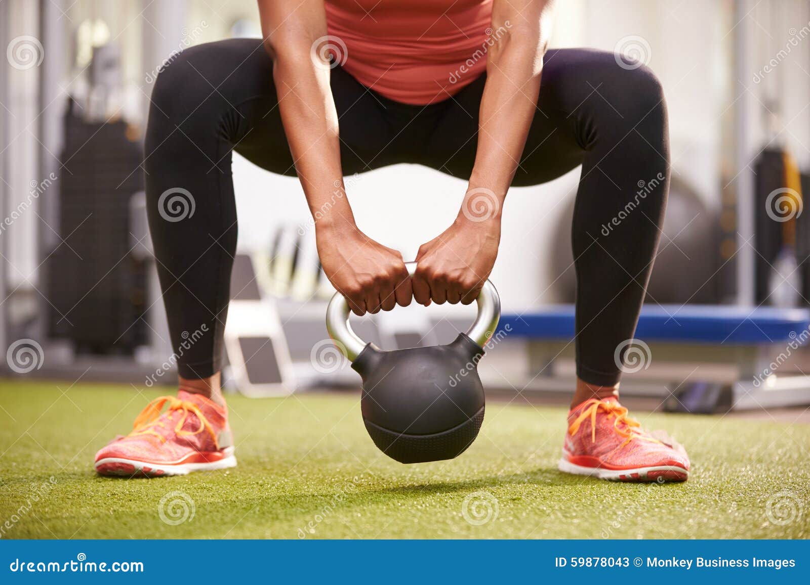Woman Exercising with a Kettlebell Weight, Front View Low-section Crop ...