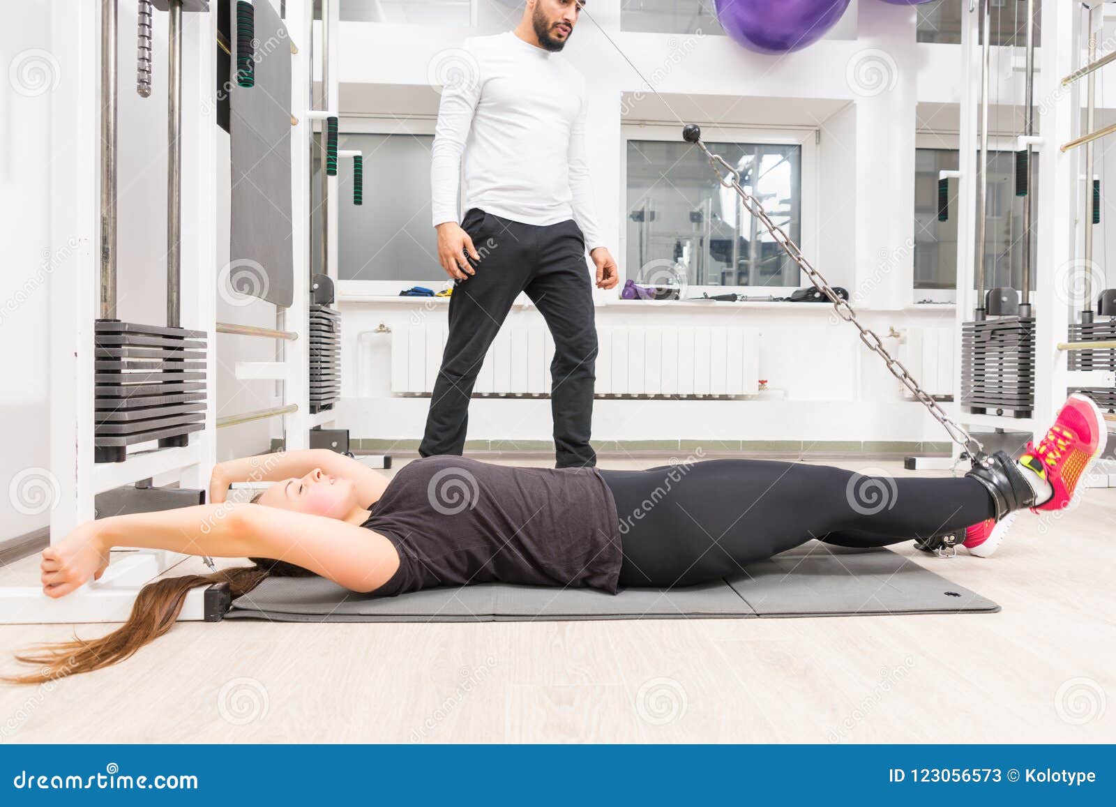 Woman Exercising Legs on Cable Machine at Gym Stock Image - Image of ...
