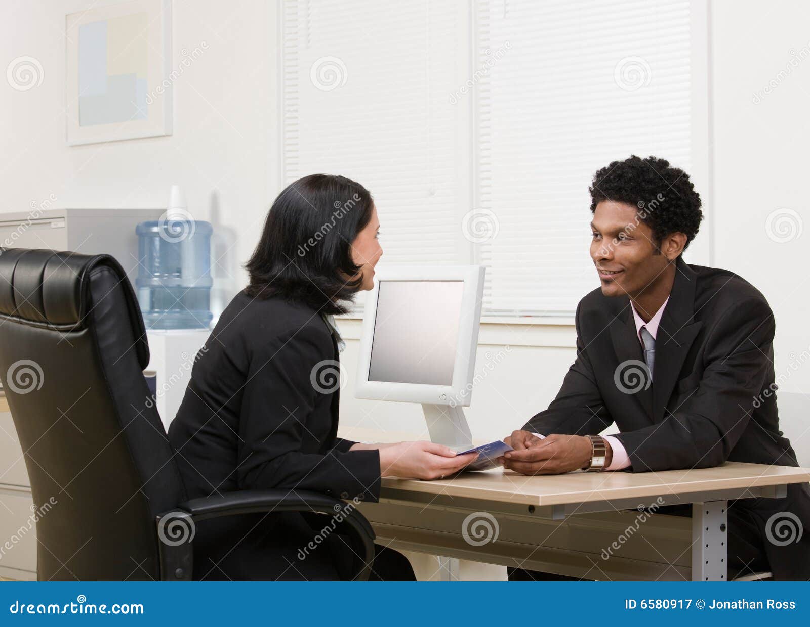 Woman Explaining Financial Brochure To Co-worker Stock Image - Image of ...