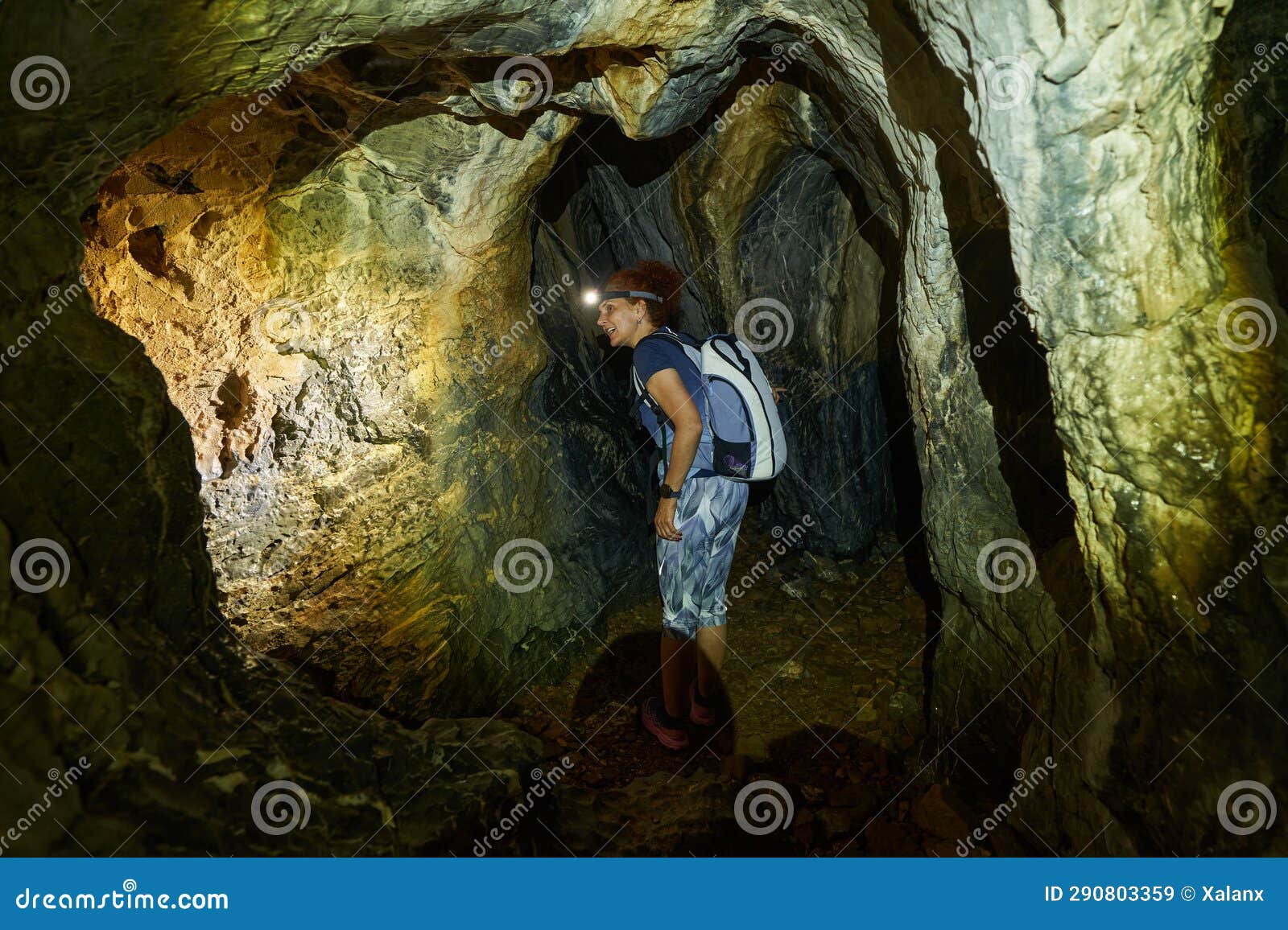 Woman exploring a cave stock image. Image of lifestyle - 290803359