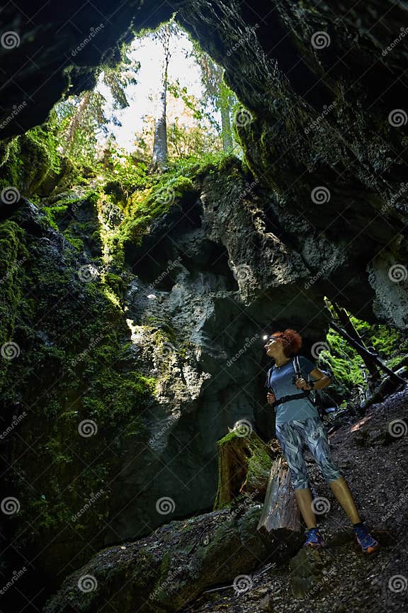 Woman exploring a cave stock image. Image of outdoor - 290803375