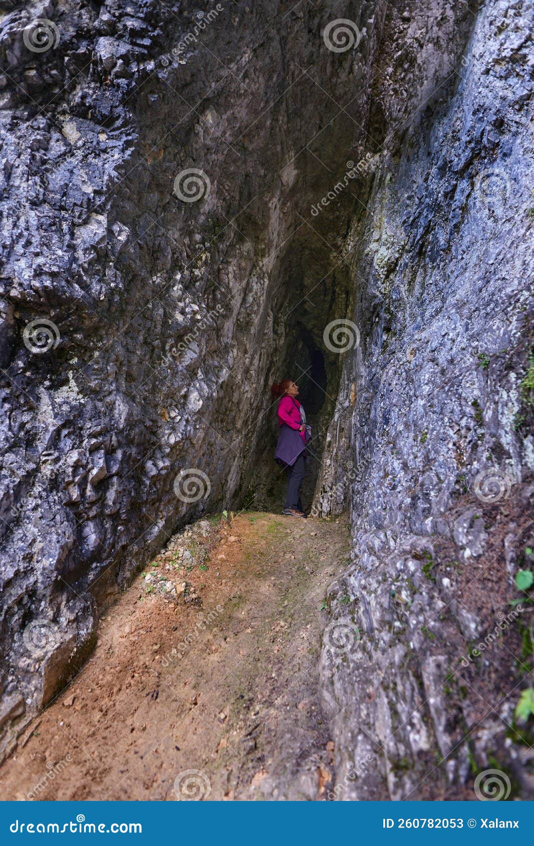 Woman exploring a cave stock image. Image of outdoor - 260782053