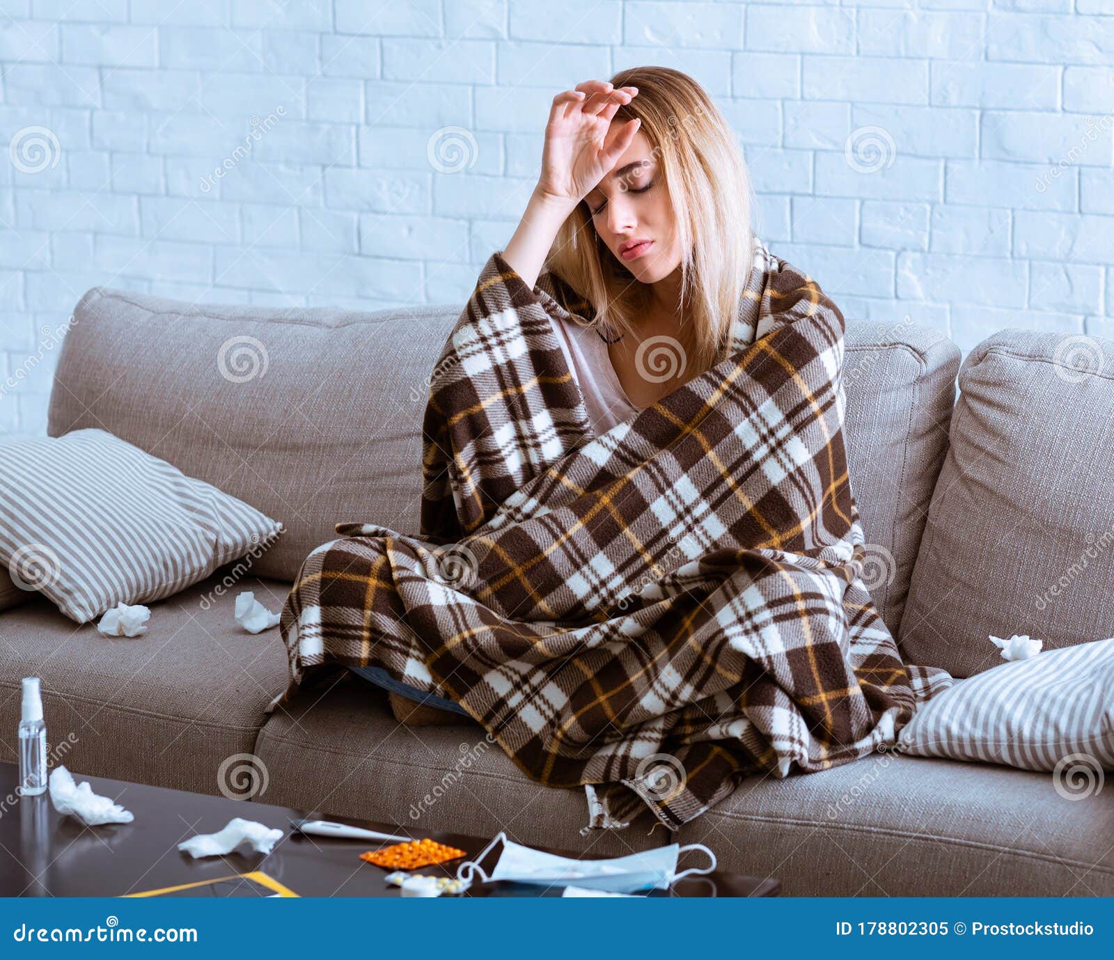 Woman Feeling Cold, Covered Blanket and Touches Forehead Stock Image ...
