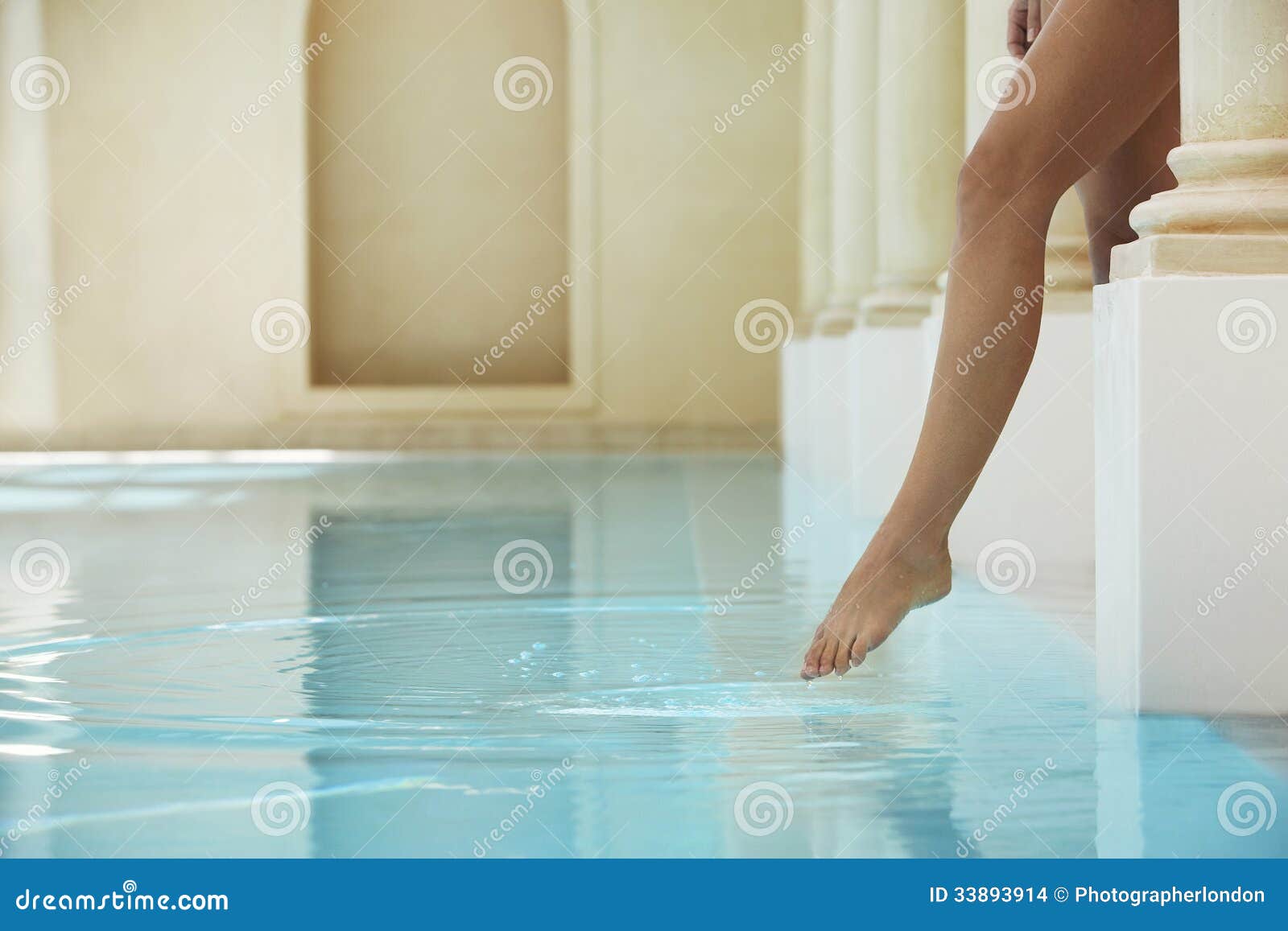 Woman Feeling the Water Temperature by Poolside Stock Photo - Image of ...