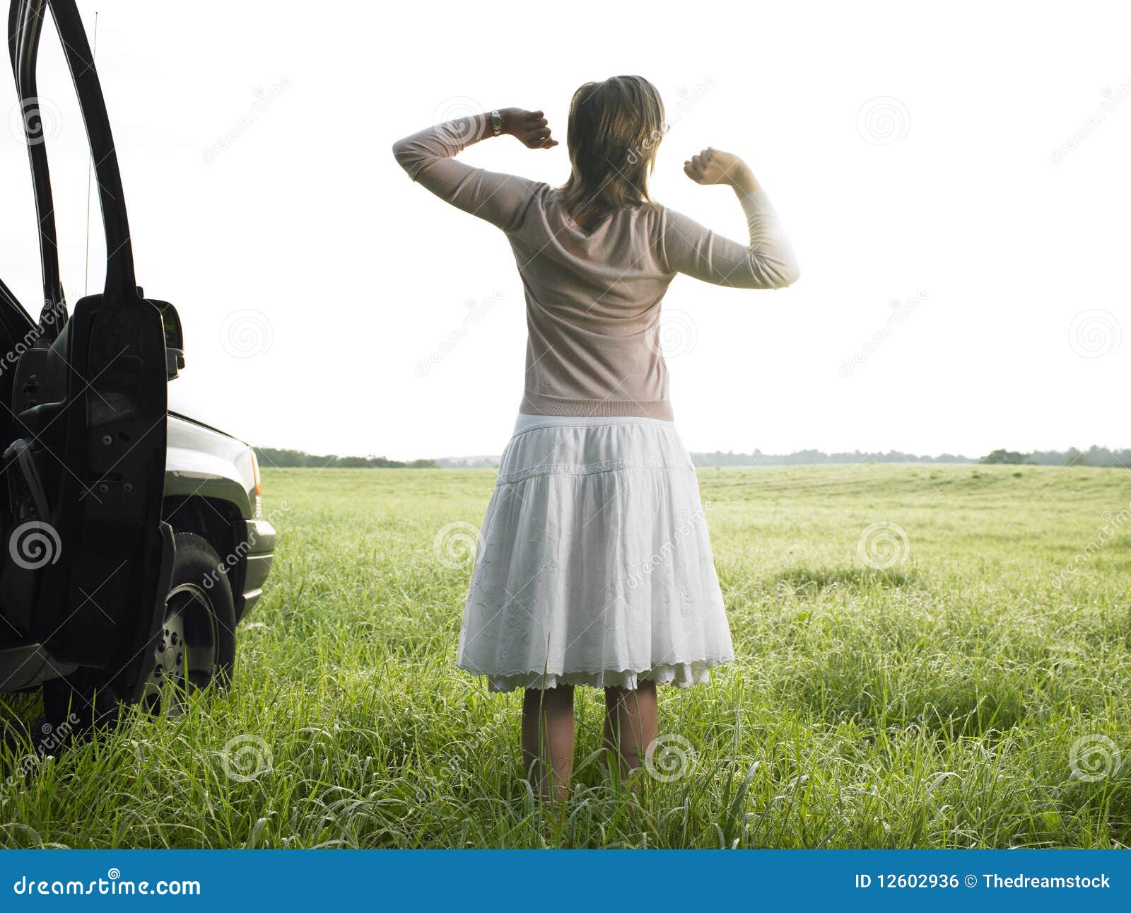 Woman in Field Stretching stock photo. Image of focus - 12602936