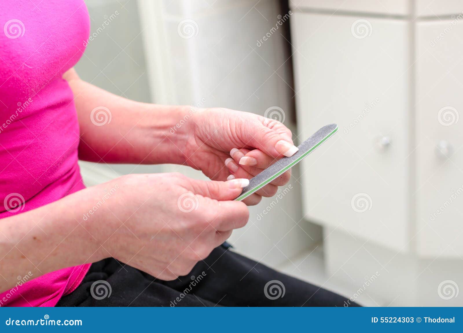Woman filing her nails stock image. Image of finger, cosmetics - 55224303