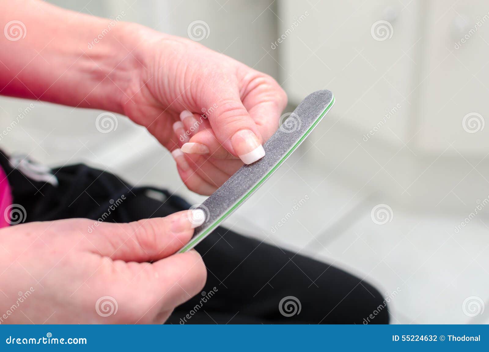 Woman filing her nails stock photo. Image of bathroom - 55224632