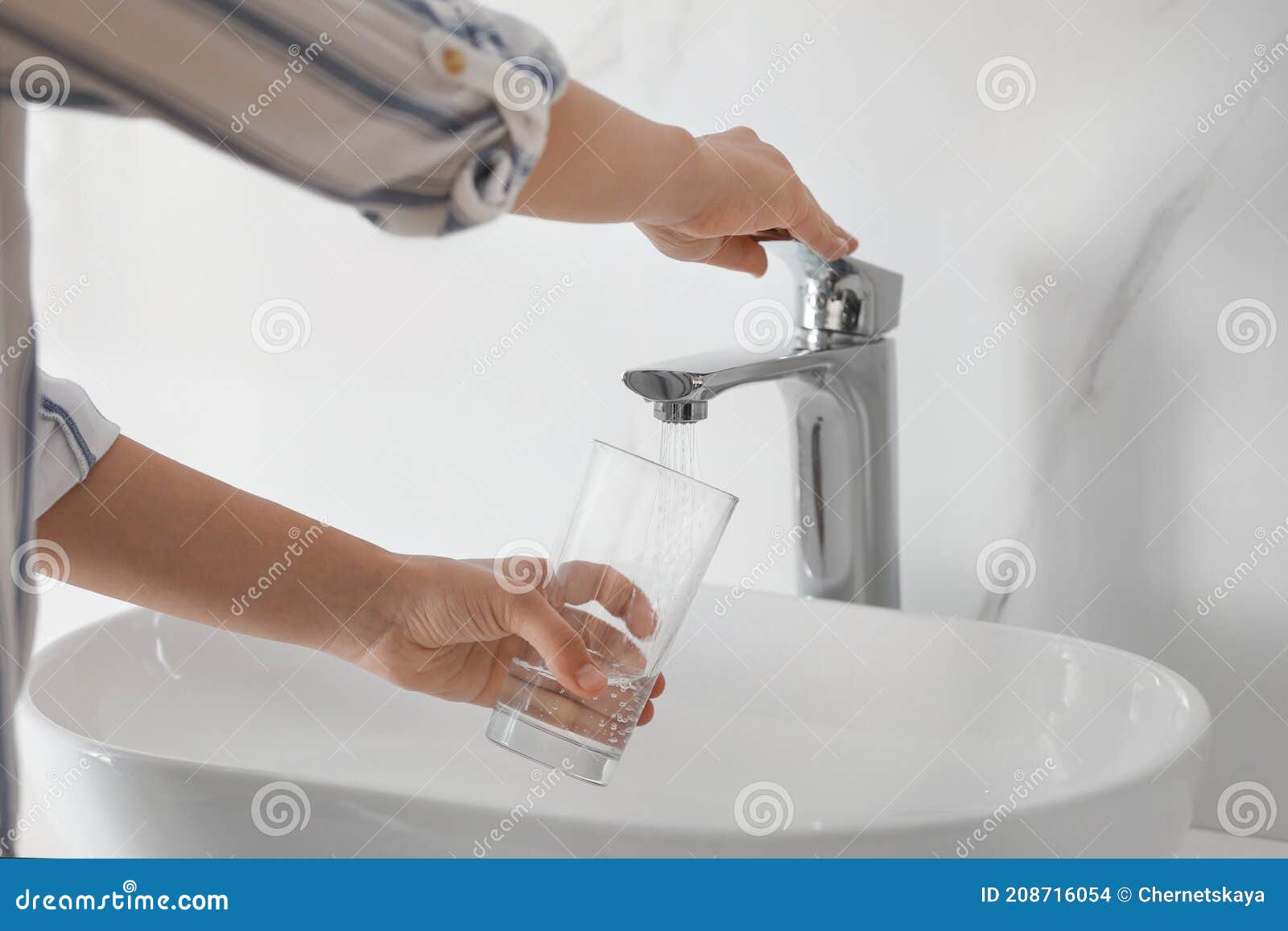 Woman Filling Glass With Water From Faucet Over Sink Closeup Stock