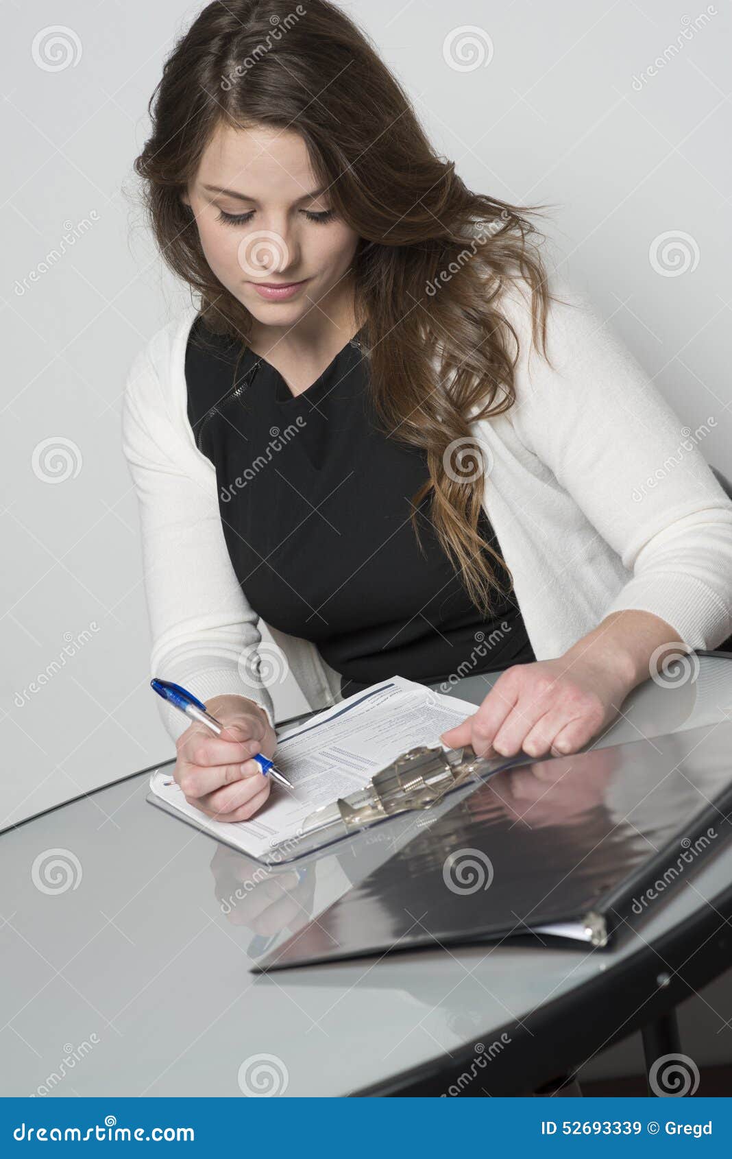 Woman filling out form stock image. Image of brunette - 52693339