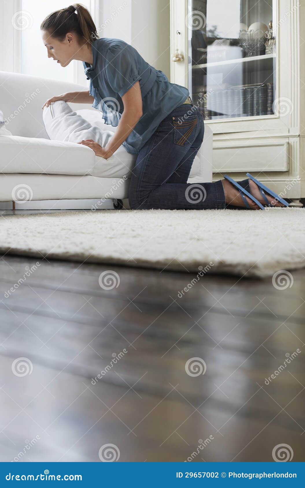 Woman Finding Something on Sofa Stock Photo - Image of sofa, lifestyle ...