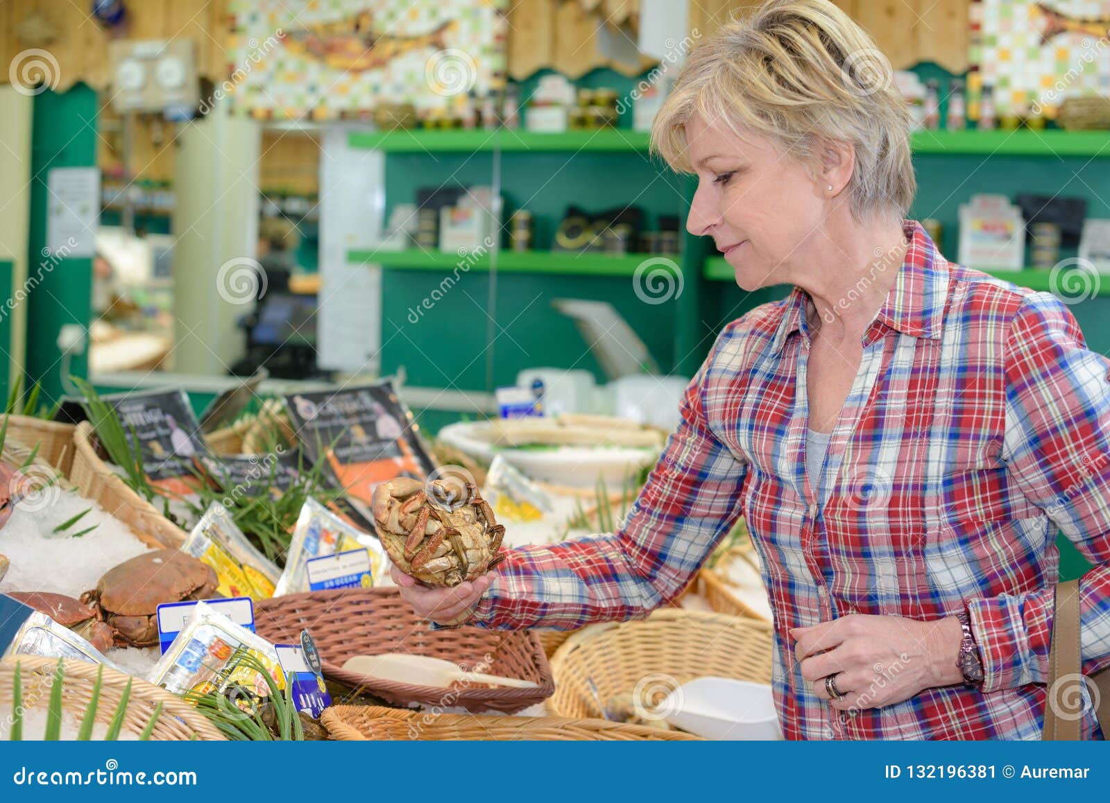 Woman at Fish Counter Holding Crab Stock Image - Image of profile ...