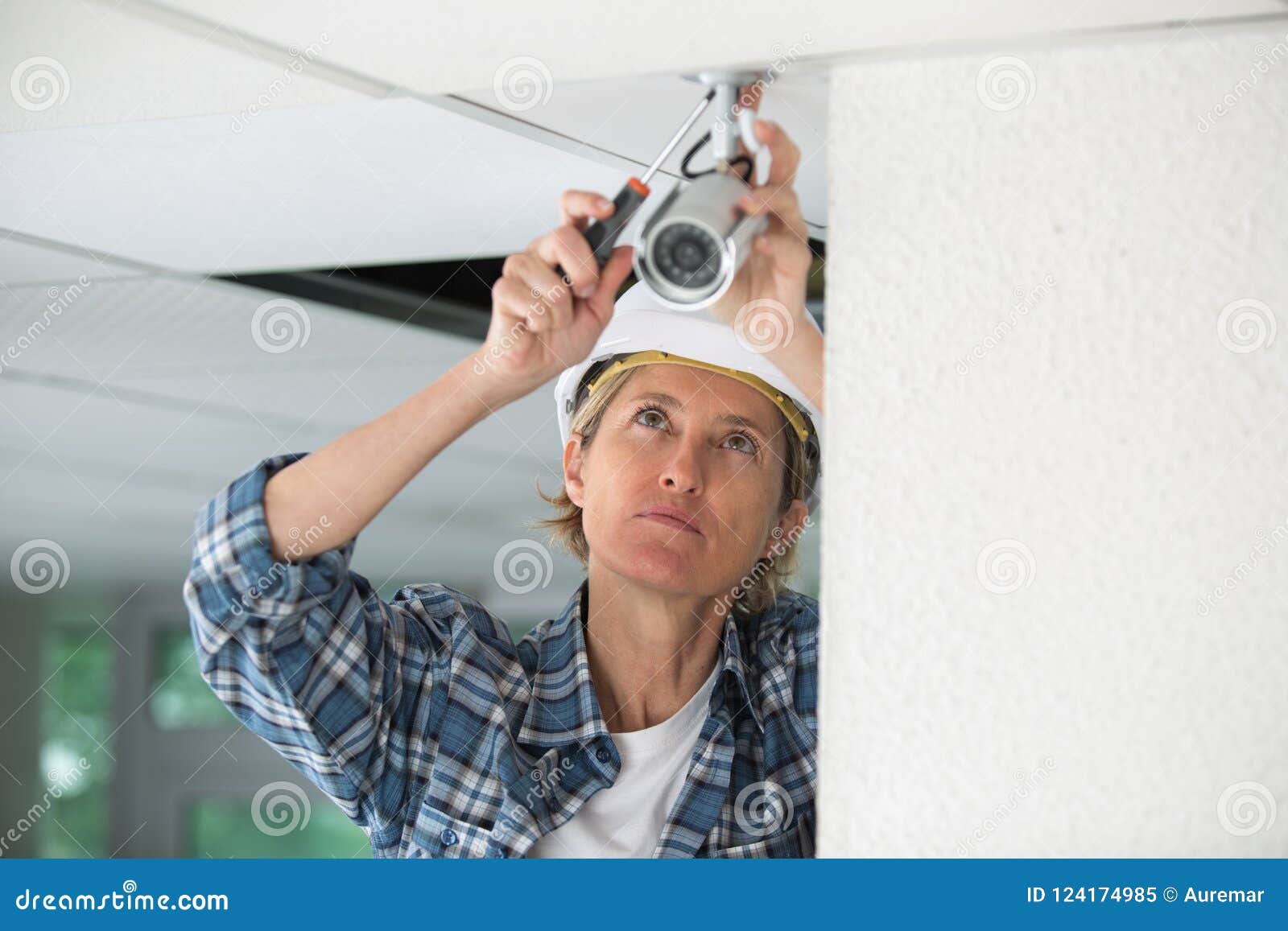 Woman Fitting Cctv Camera Indoors Stock Image - Image of secure, woman ...