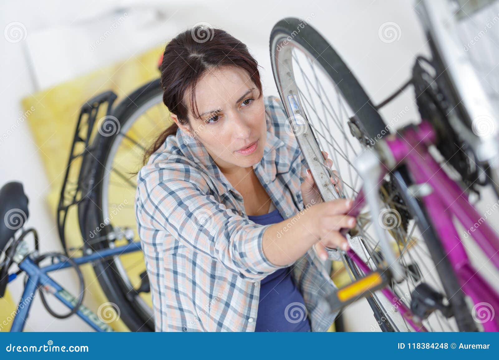 Woman fixing the bike stock photo. Image of department - 118384248