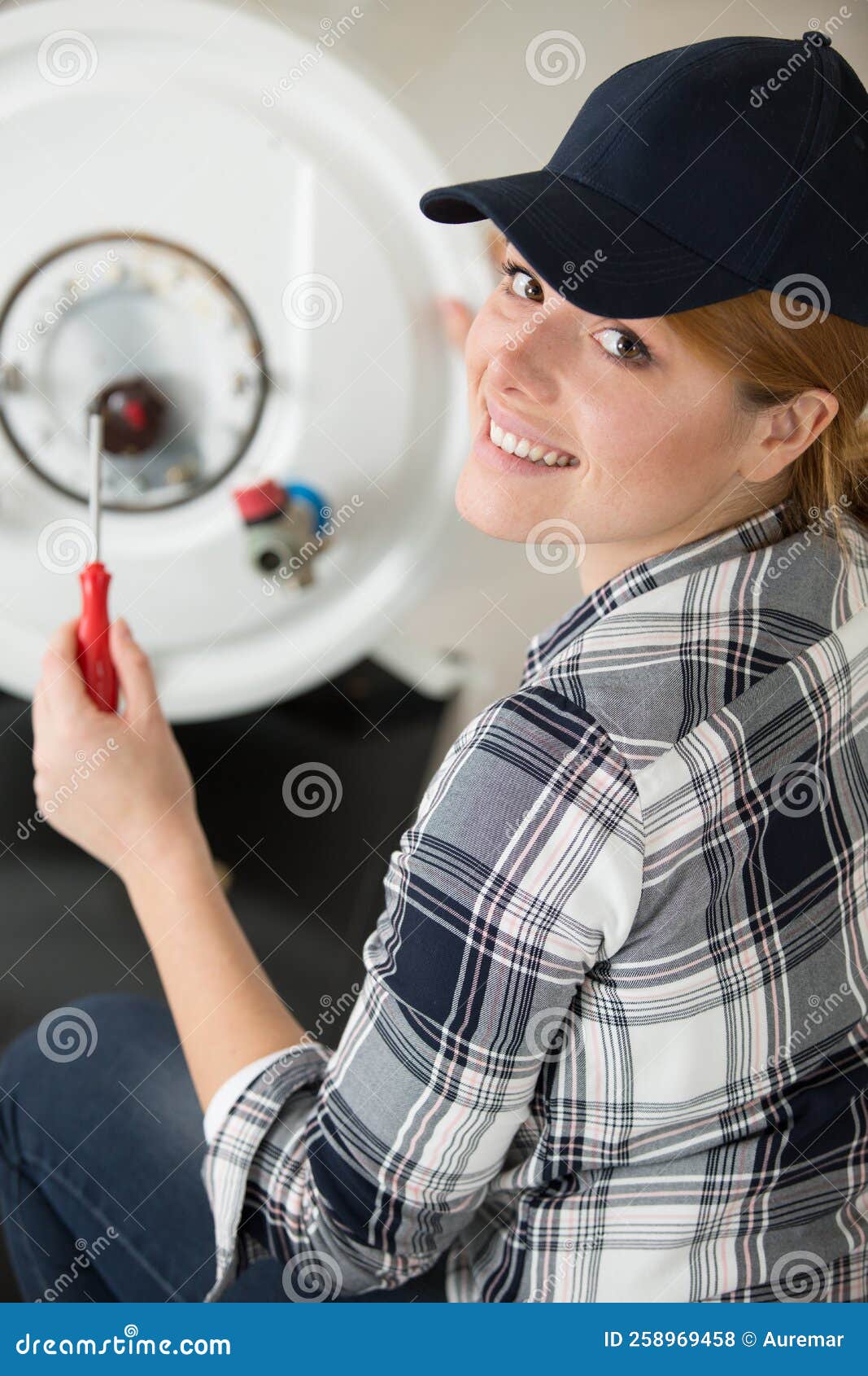 Woman fixing a boiler stock photo. Image of career, side - 258969458
