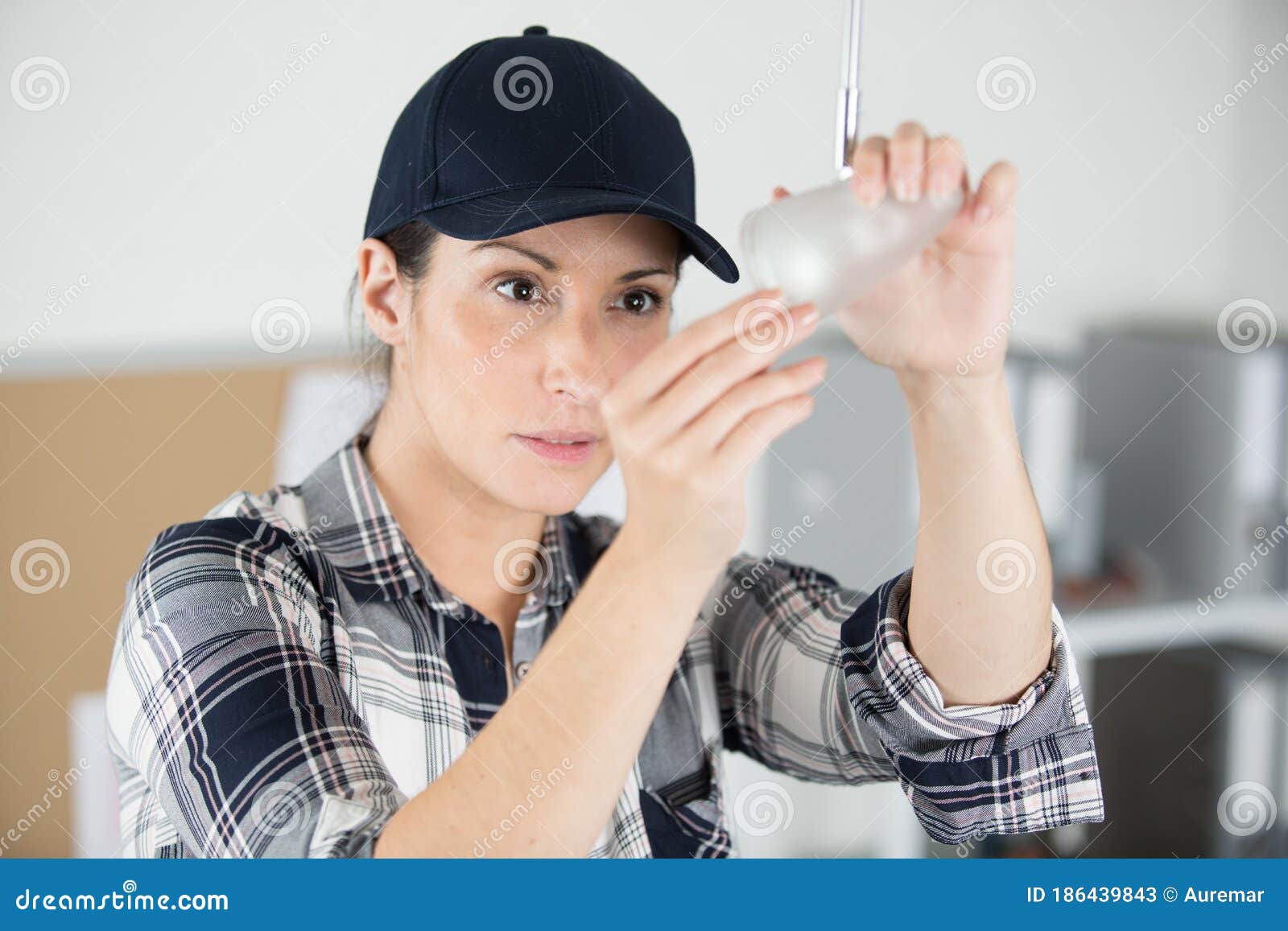 Woman fixing broken lamp stock image. Image of decorating - 186439843