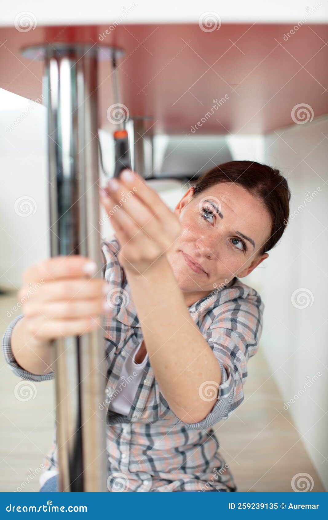 Woman fixing leg table stock image. Image of metal, improvement - 259239135