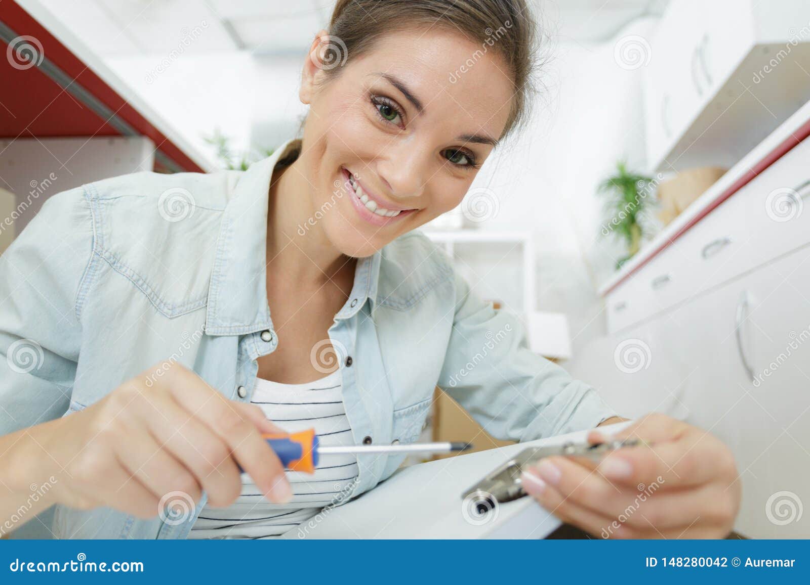 Woman fixing a machine stock photo. Image of appliance - 148280042