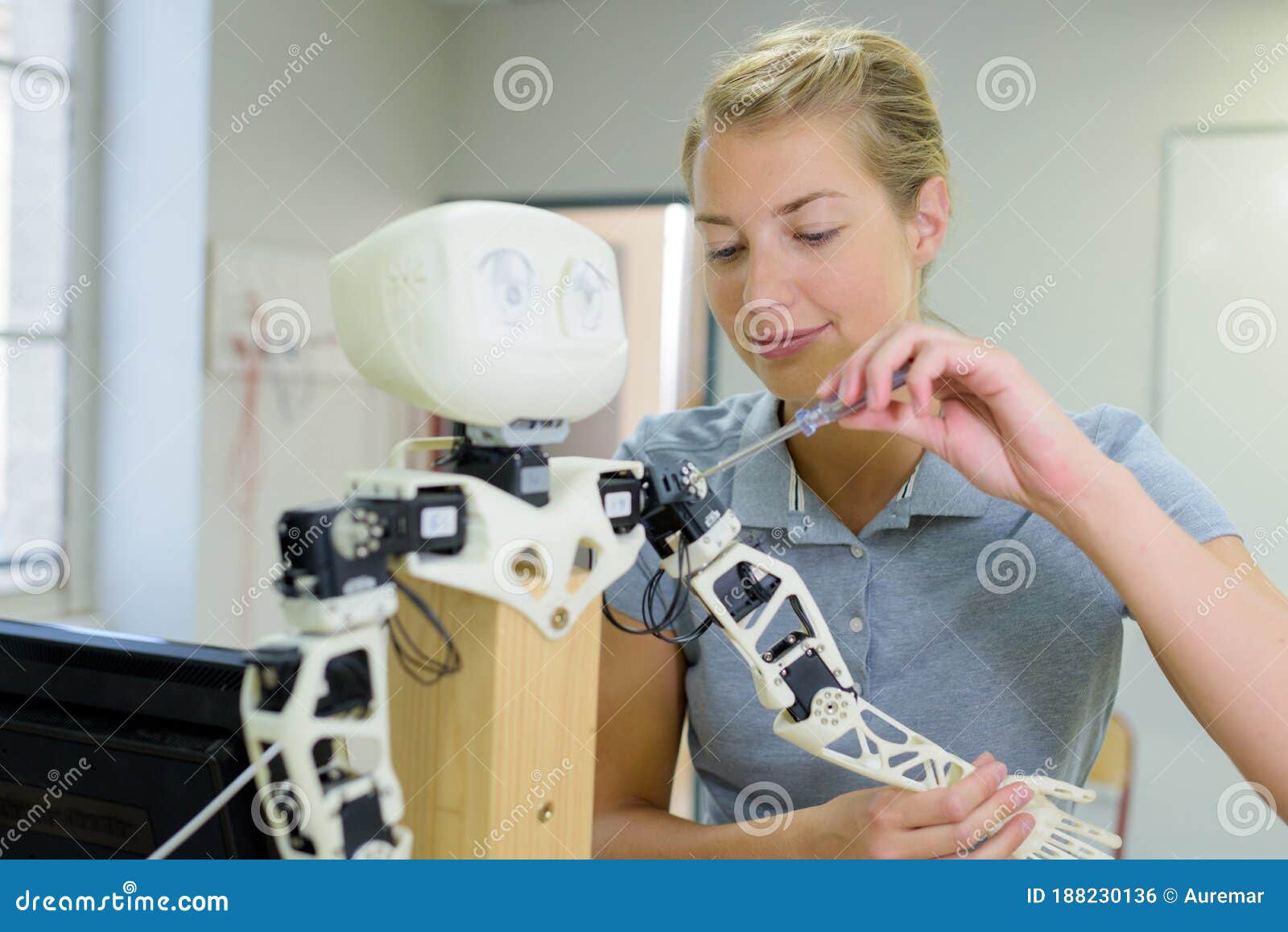 Woman fixing robotic arm stock photo. Image of factory - 188230136