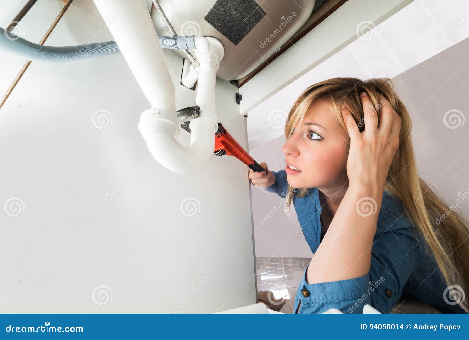 Woman Fixing Sink Pipe with Wrench in Kitchen Stock Photo - Image of ...