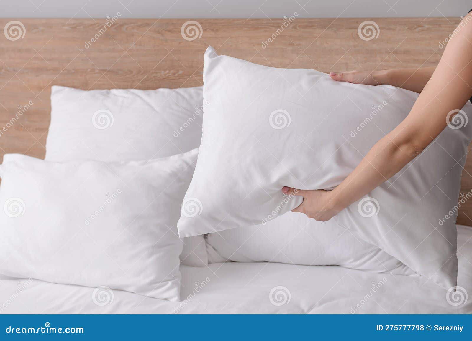 Woman Fluffing Soft Pillows on Bed Stock Photo - Image of clean, home ...