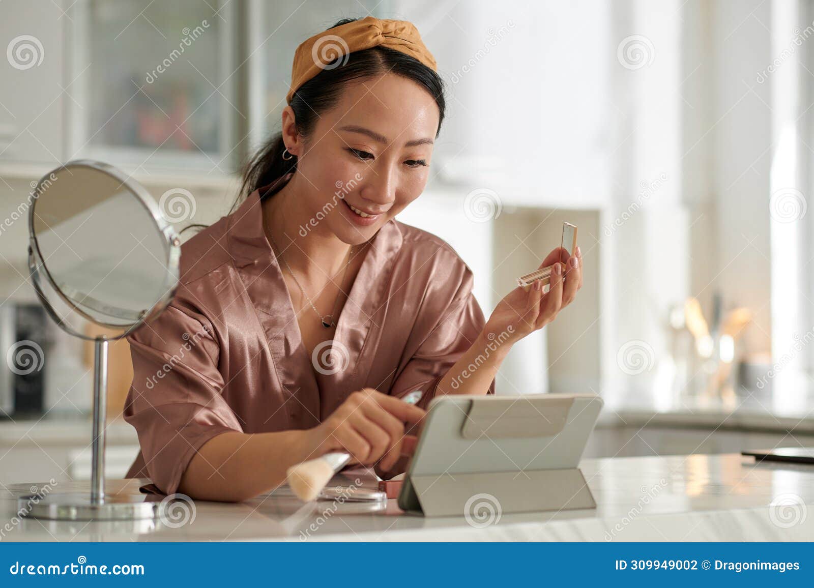 Woman Following Makeup Tutorial Stock Photo - Image of beauty, watch ...