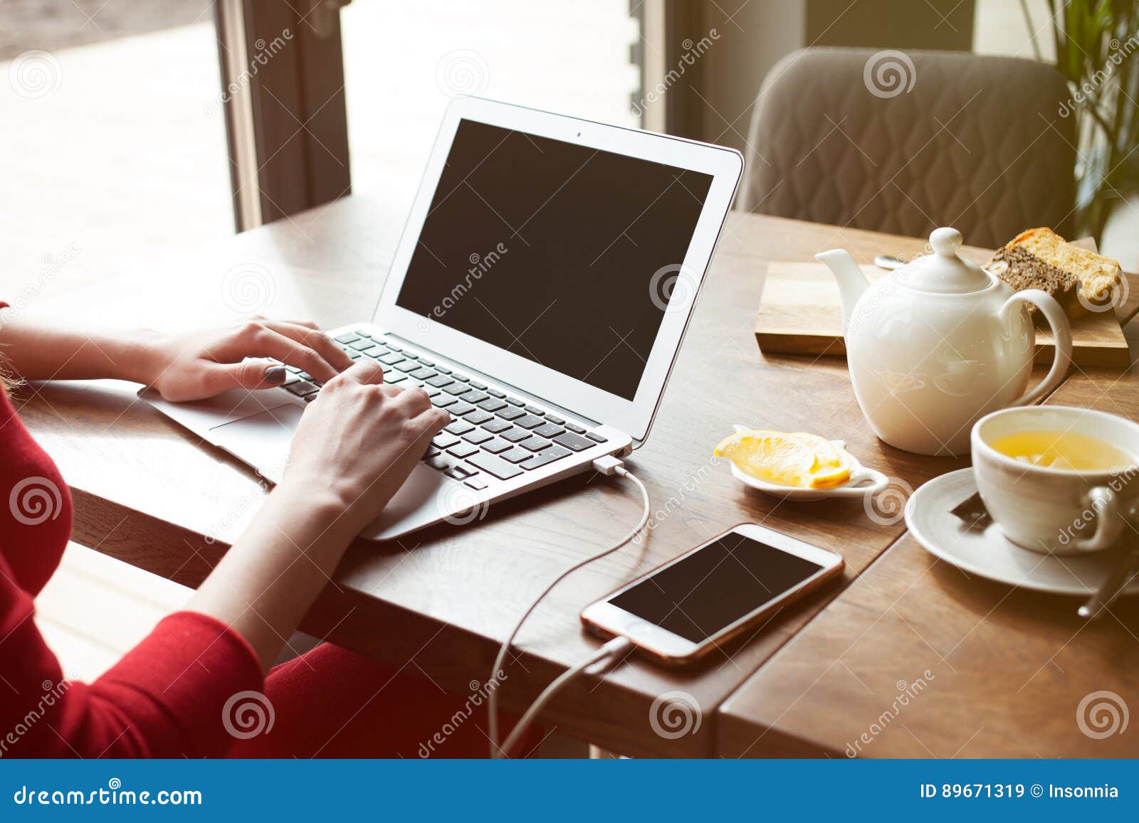 Woman Freelancer is Using Laptop Computer for Remote Work while Having ...