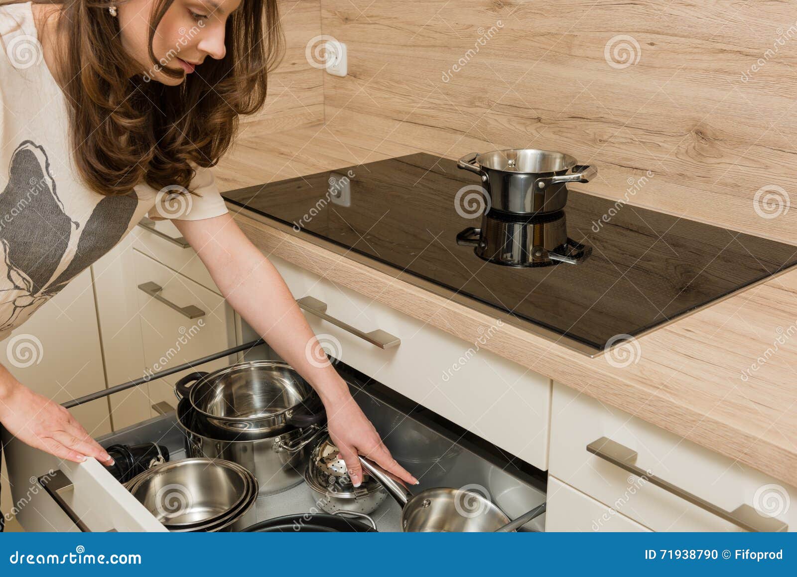 Woman in Front of Modern Cooker with Open Drawer Under the Stove Stock ...