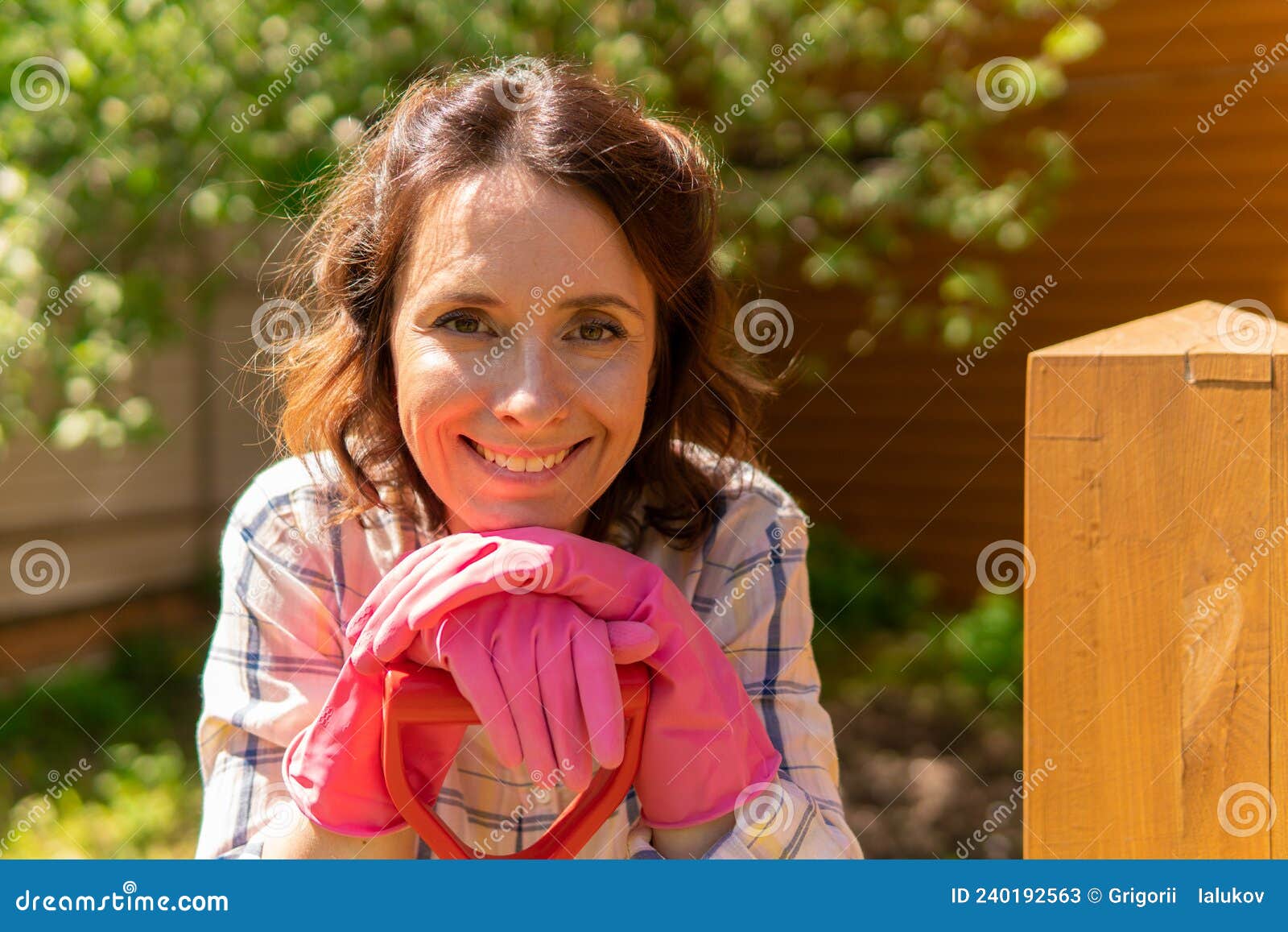 A Woman Is Gardening In Her Backyard She Plants Seedlings Stock Image