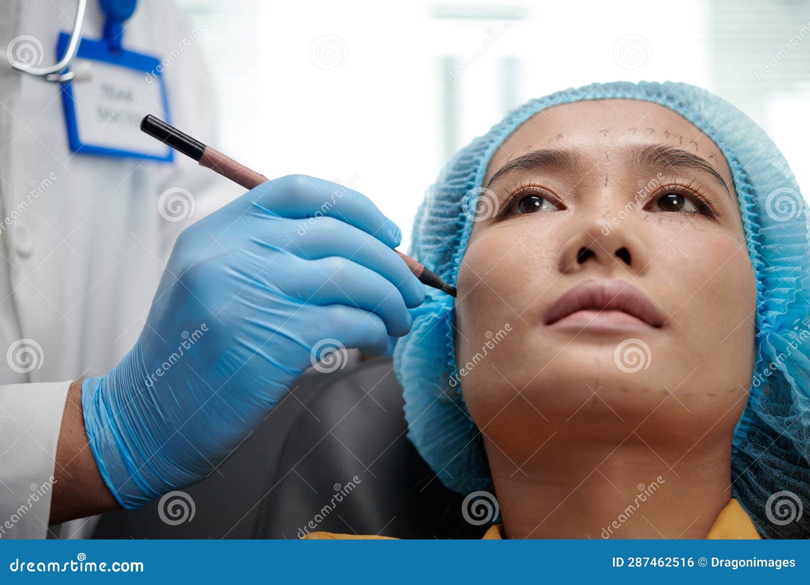 Woman Getting Face Marked stock photo. Image of face - 287462516