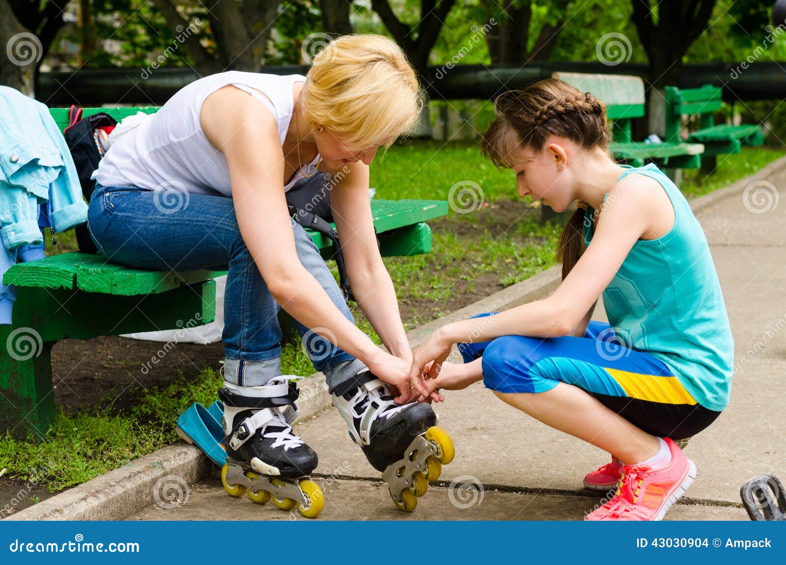 Woman Getting Help Putting on Rollerblades Stock Photo - Image of blond ...