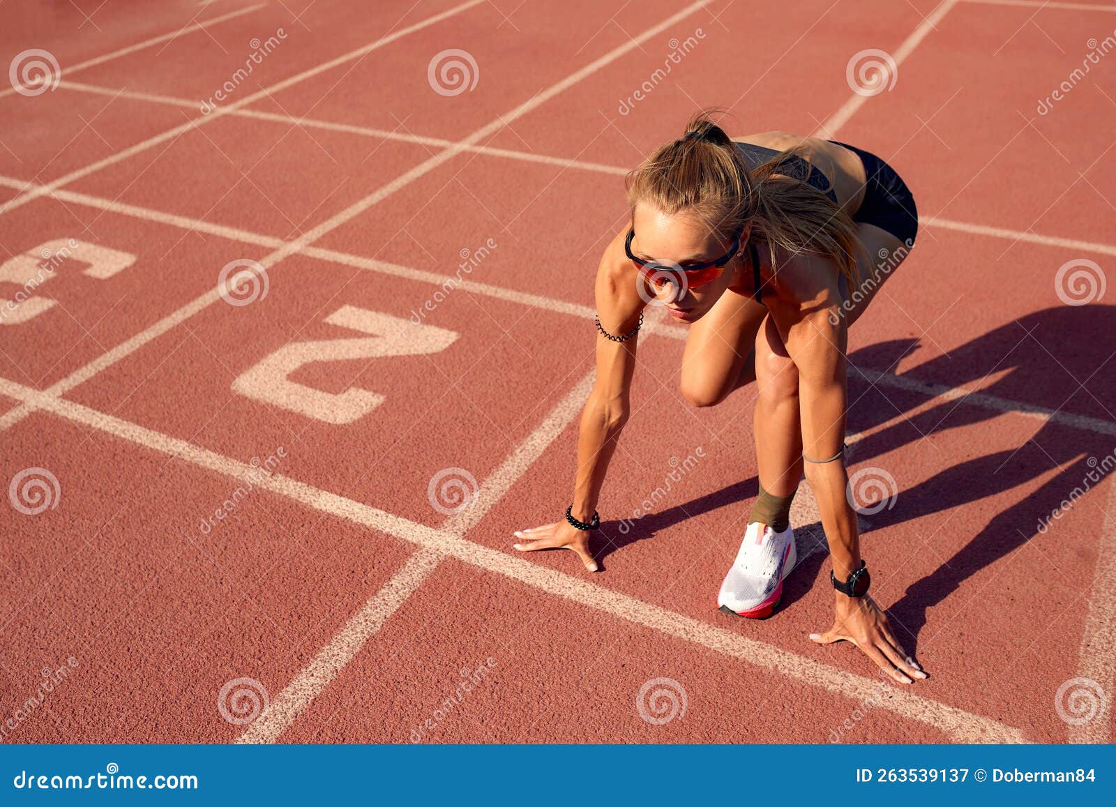 Woman Getting Ready To Start on Stadium - Summer Outdoors Training ...