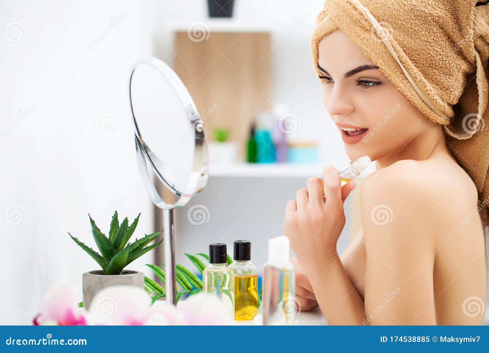 Woman Getting Ready for Work Doing Morning Makeup in Bathroom Mirror at ...