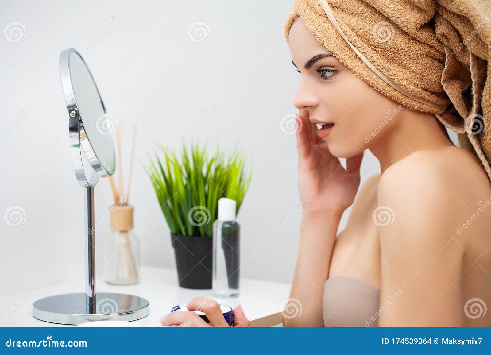 Woman Getting Ready for Work Doing Morning Makeup in Bathroom Mirror at ...