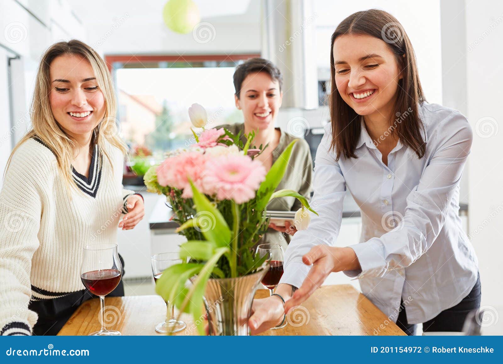 Woman with Girlfriends at Table Setting for Lunch in Kitchen Stock ...