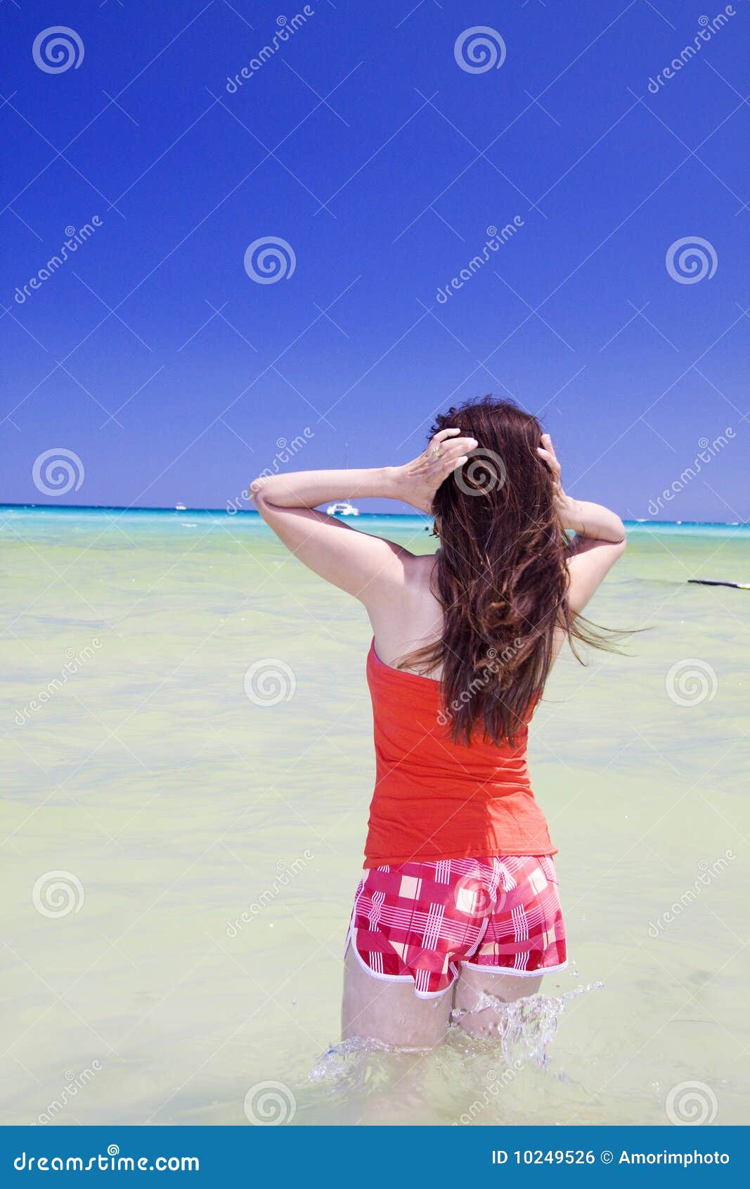Woman going into the water stock photo. Image of holiday - 10249526
