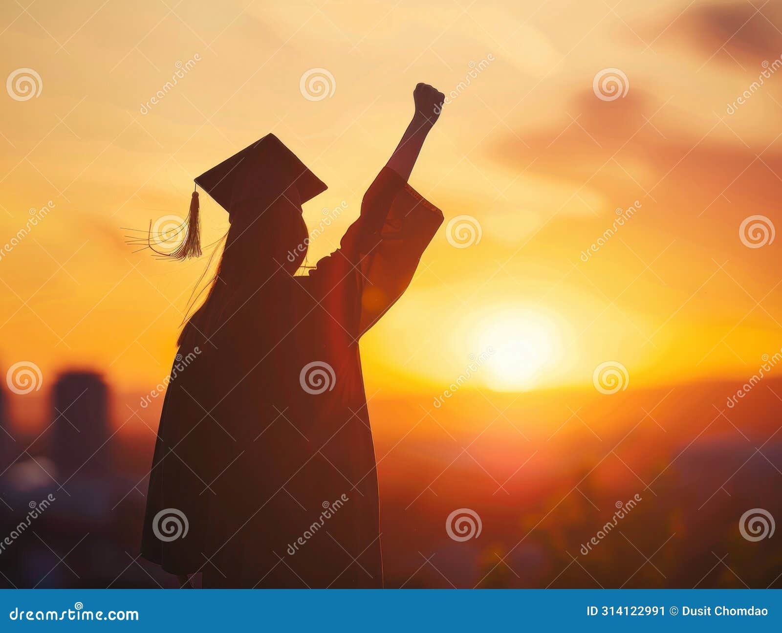 A Woman in a Graduation Cap and Gown is Standing in Front of a Sunset ...