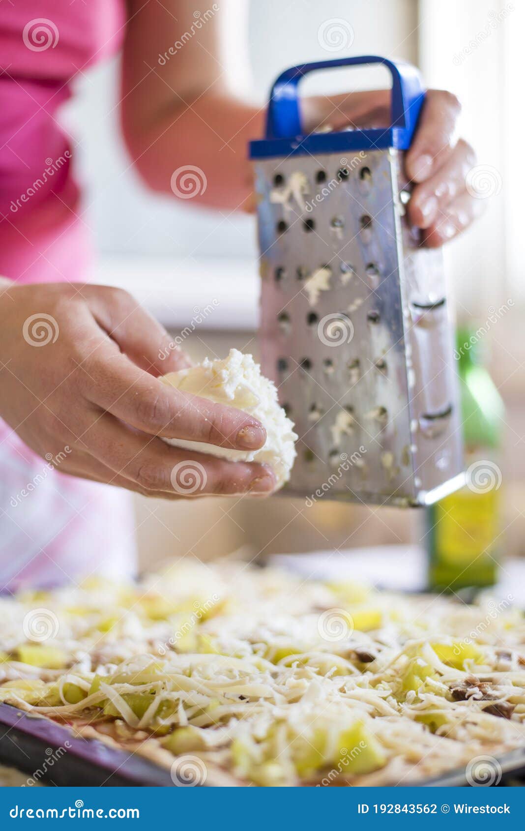 Woman Grating the Cheese on the Pizza with the Cheese Grater Stock ...