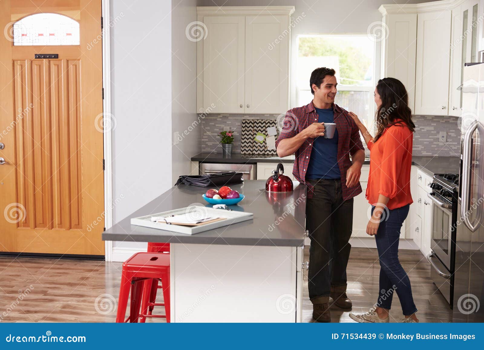 Woman Greeting Man Returning Home from Work Stock Image - Image of ...