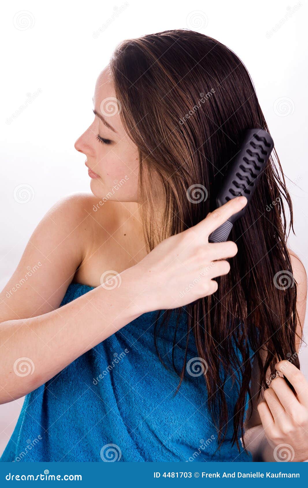Woman is grooming her hair stock image. Image of bathrobe - 4481703
