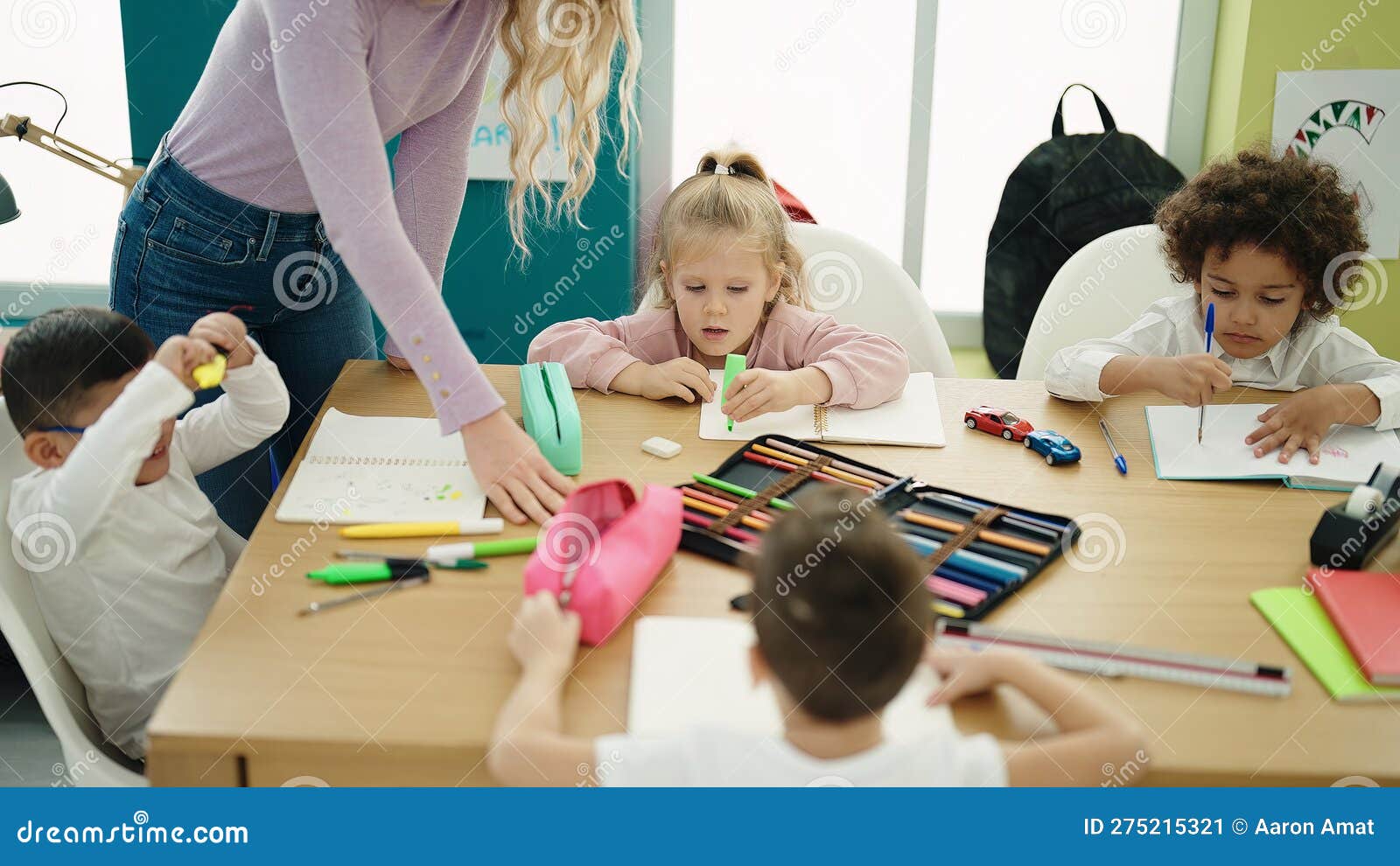 Woman and Group of Kids Having Lesson Sitting on Table at Classroom ...