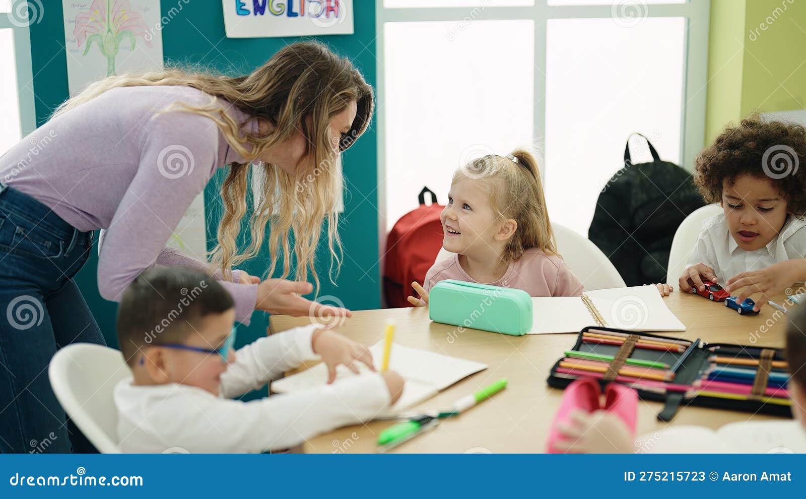 Woman and Group of Kids Having Lesson Sitting on Table at Classroom ...