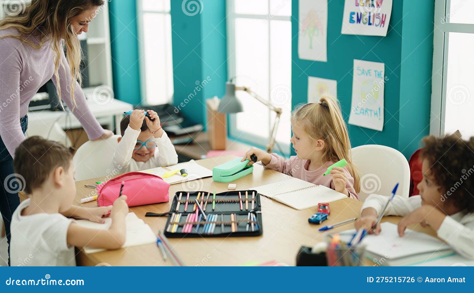 Woman and Group of Kids Having Lesson Sitting on Table at Classroom ...
