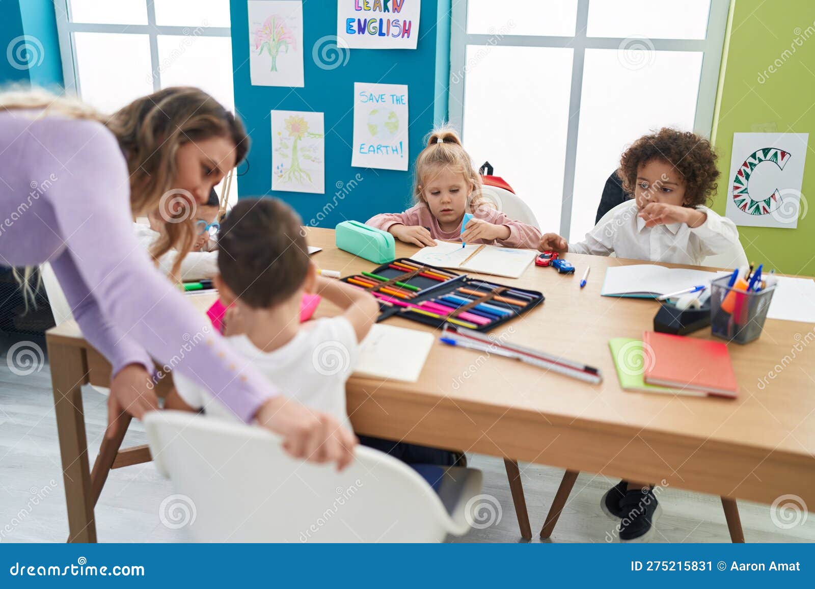 Woman and Group of Kids Having Lesson Sitting on Table at Classroom ...