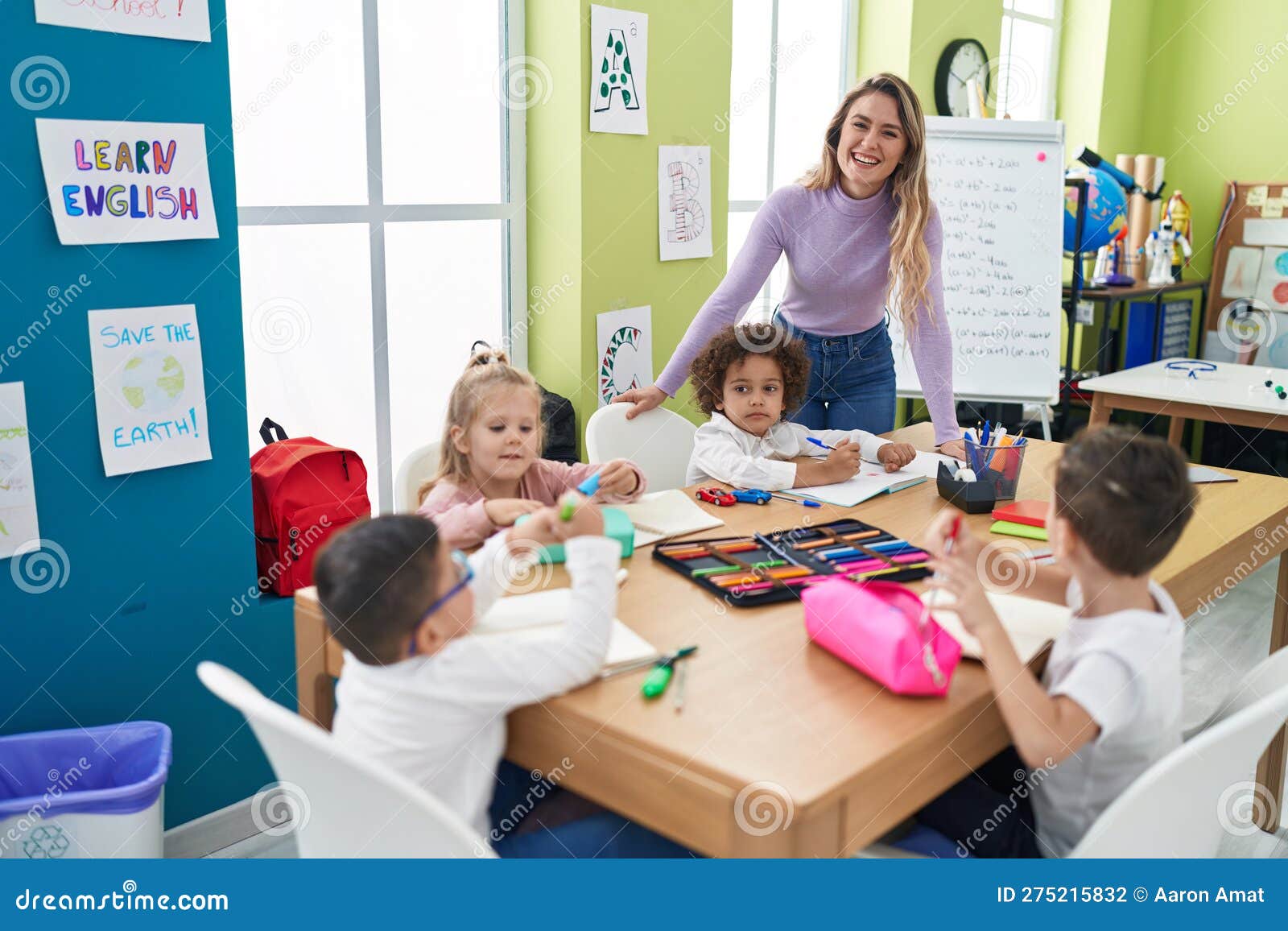 Woman and Group of Kids Having Lesson Sitting on Table at Classroom ...