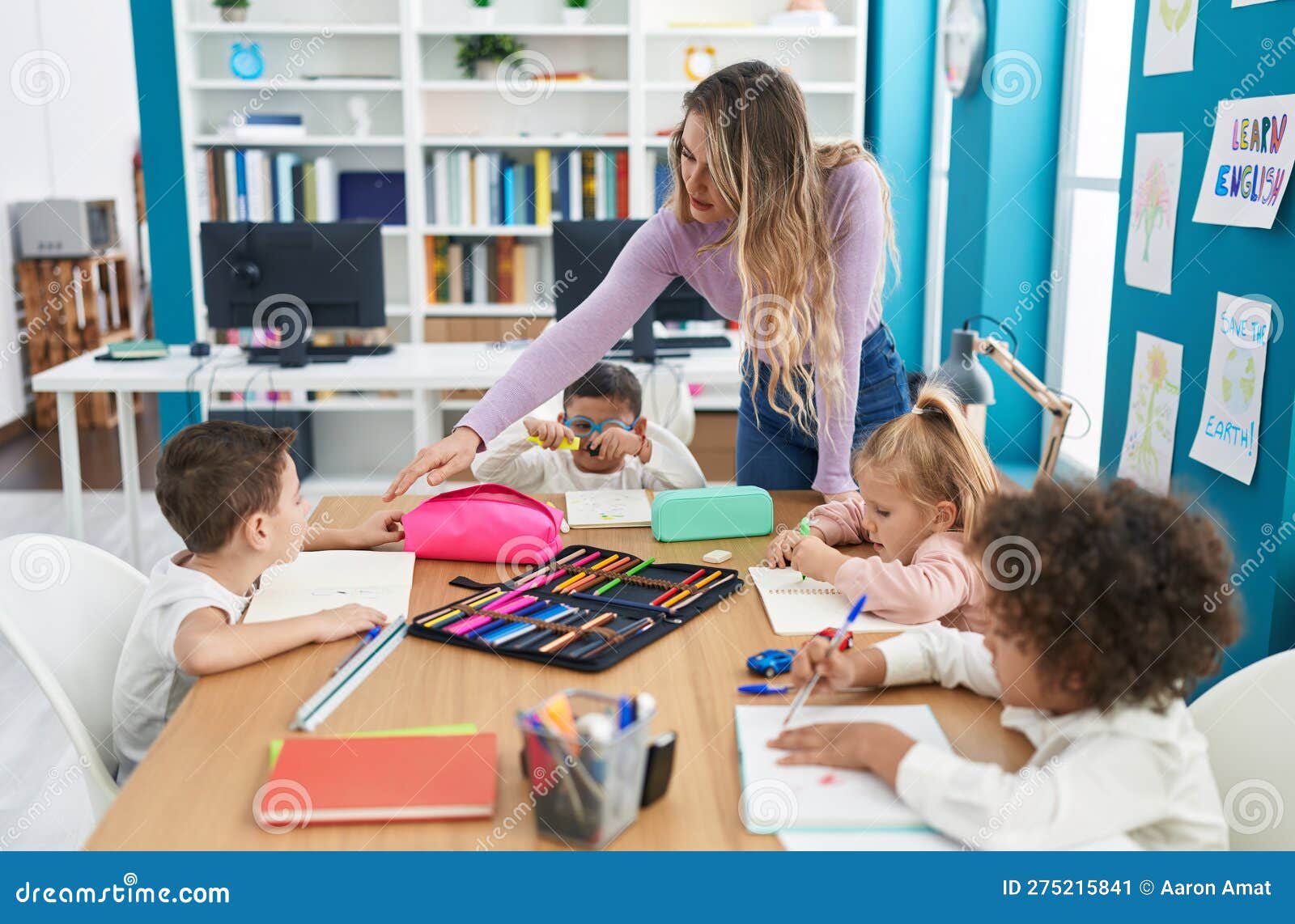 Woman and Group of Kids Having Lesson Sitting on Table at Classroom ...