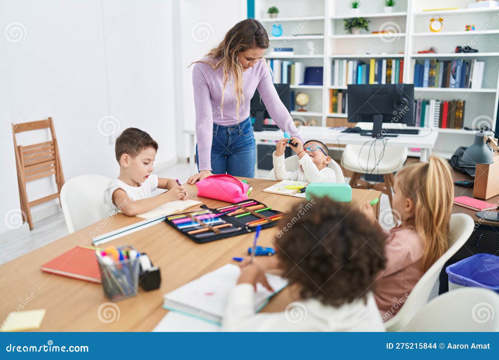Woman and Group of Kids Having Lesson Sitting on Table at Classroom ...