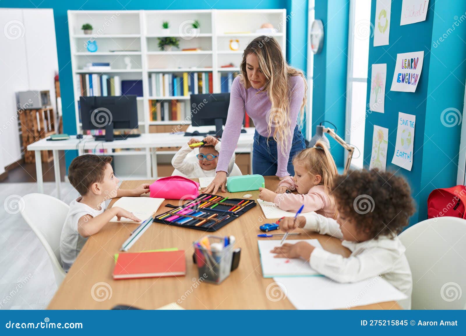 Woman and Group of Kids Having Lesson Sitting on Table at Classroom ...